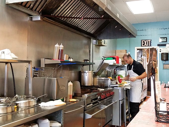 The kitchen reveals where the magic happens—a well-seasoned grill that has witnessed thousands of patties transformed into legendary fritas.