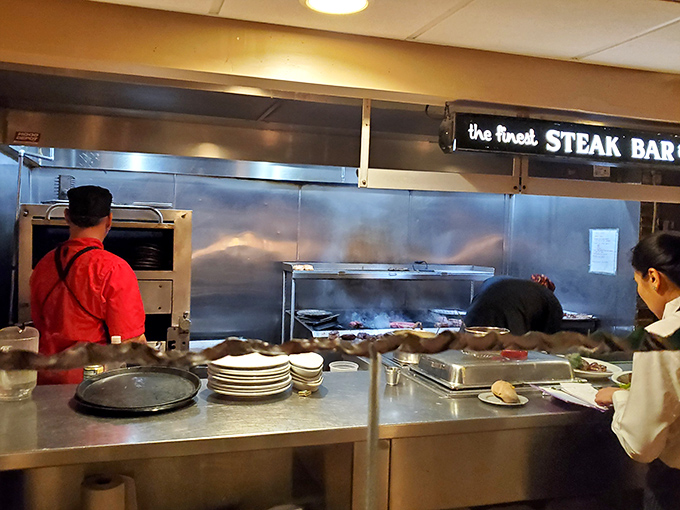 A glimpse into the kitchen reveals the heart of the operation&mdash;where "the finest STEAK BAR" isn't just a sign, it's a promise.
