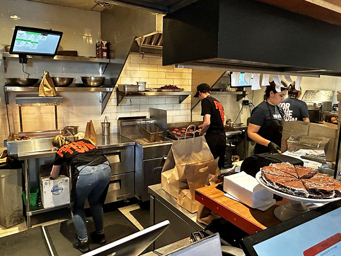 The kitchen ballet in full swing. No fancy pyrotechnics or tweezers here&mdash;just skilled hands creating consistently perfect burgers.