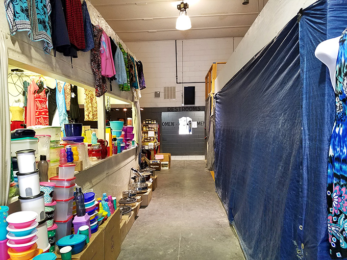The indoor corridor reveals the market's depth. Plastic containers in rainbow hues line the walls, practical treasures waiting to be discovered.
