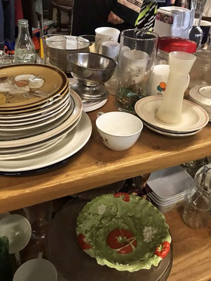 Mismatched dishes with more personality than most dinner guests. That lettuce-shaped bowl has definitely served some interesting salads in its day.