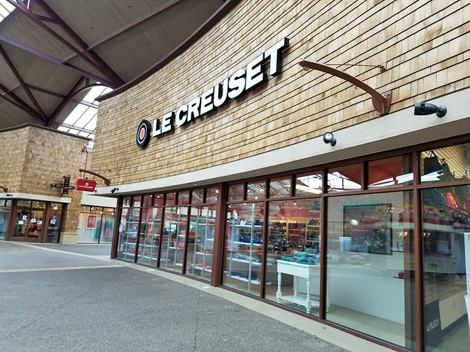 Le Creuset's colorful cookware gleams through the windows, tempting home chefs to upgrade their kitchen arsenal at prices that won't require a second mortgage.
