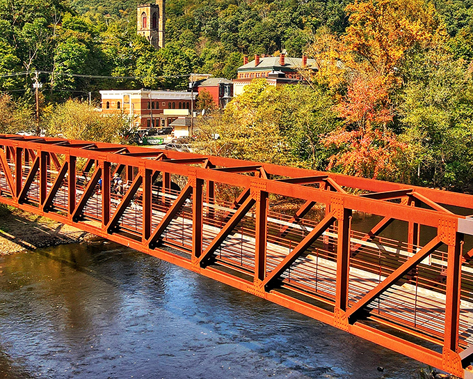 The iconic red bridge creates a perfect frame for autumn foliage, proving that Jim Thorpe dresses to impress in every season.