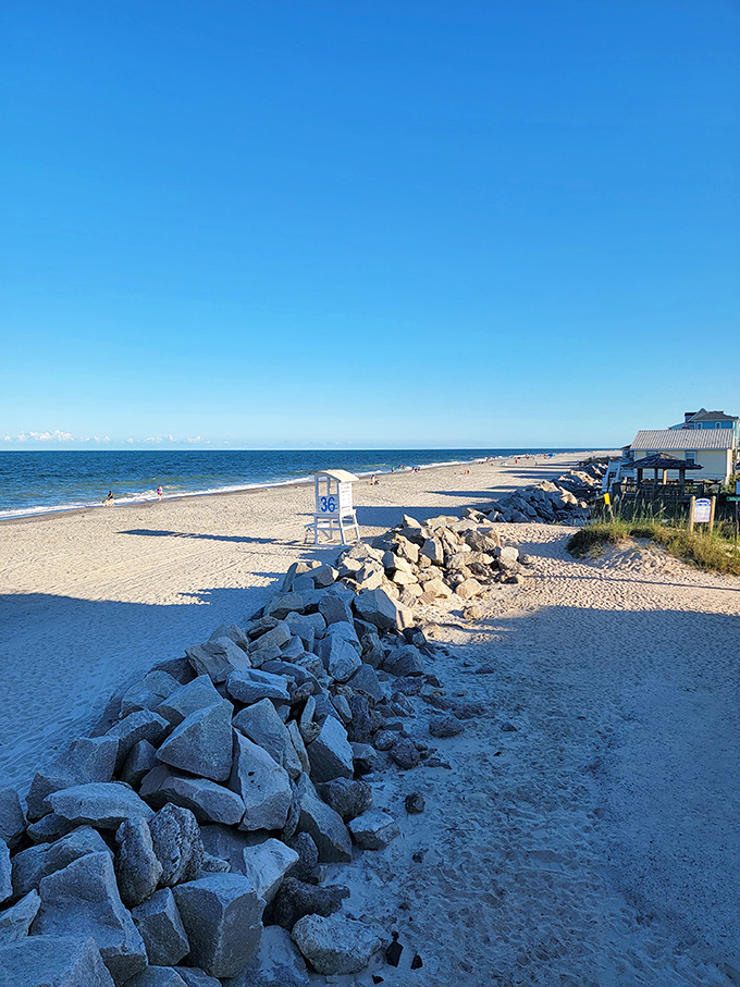 Where stone meets sand in perfect harmony. This rocky jetty creates a natural frame for Carolina Beach's endless summer.
