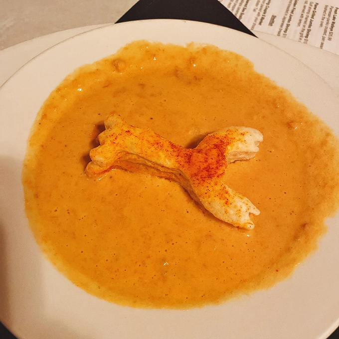 Lobster bisque so luxurious it deserves its own tax bracket, complete with a pastry lobster that's almost too adorable to submerge.