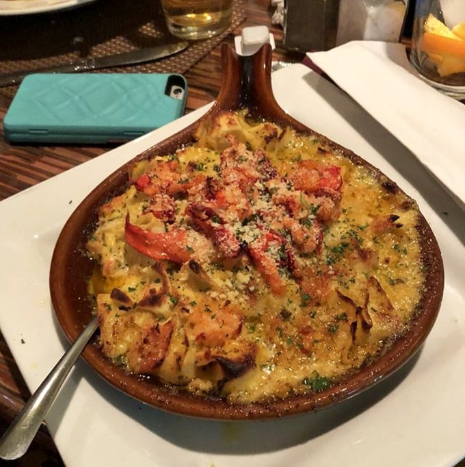 This bubbling cauldron of pasta goodness combines tomato, cheese, and seafood in what can only be described as the culinary equivalent of a group hug.