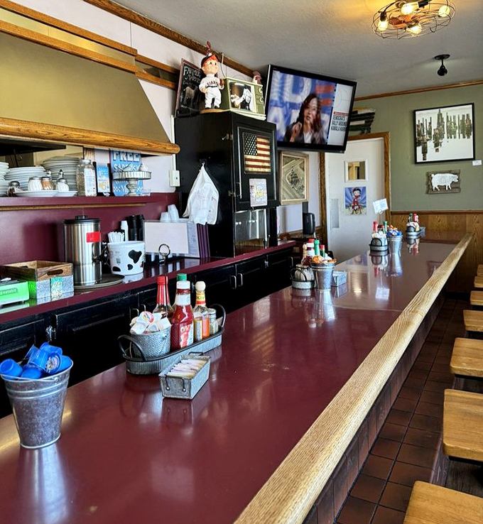 The counter stretches like a runway where breakfast dreams take flight, with each stool offering front-row seats to the morning show.