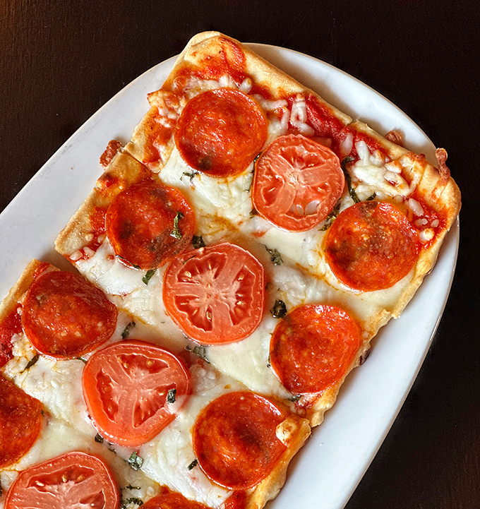 Pizza that's so good it should be illegal&mdash;the perfect ratio of pepperoni to fresh tomato slices creates harmony that rarely existed in jail.