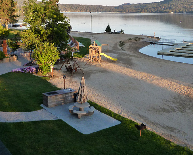 Sandy shores meet crystal waters at this lakeside beach, where mountains provide the perfect backdrop for your "wish you were here" moments.
