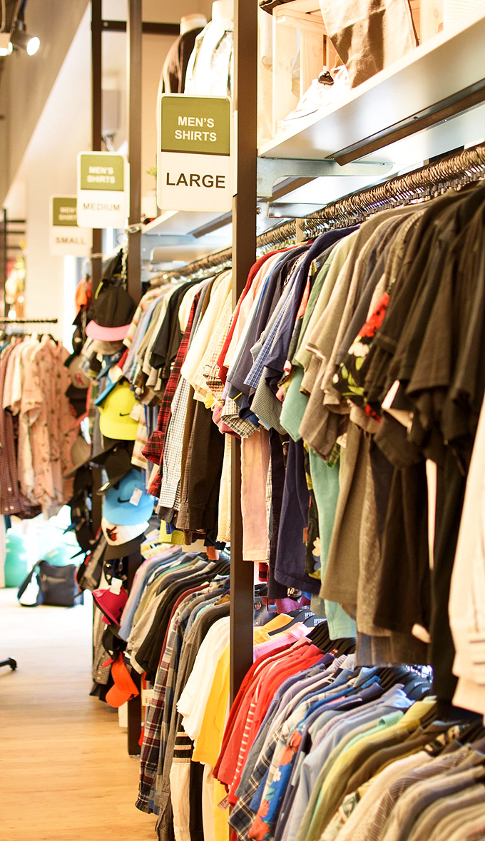 Men's shirts arranged with military precision, proving secondhand shopping can be as orderly as it is economical.