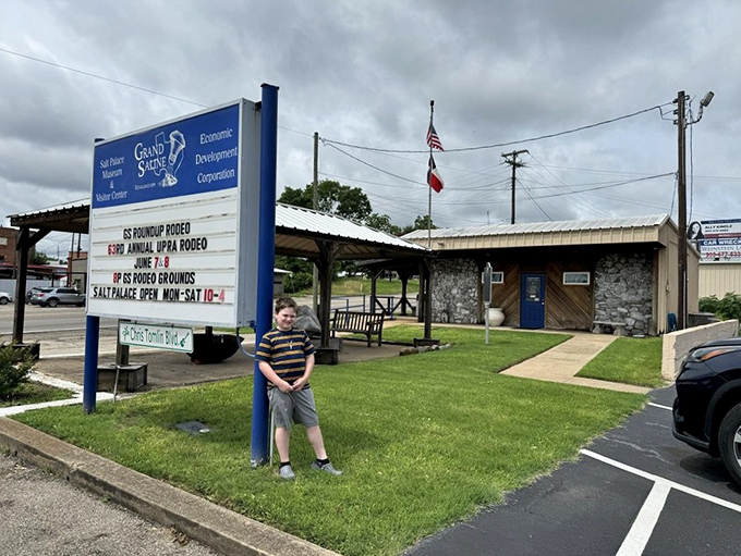 Small town charm meets geological wonder at the Salt Palace's entrance, where Texas flags wave proudly over this crystalline curiosity.
