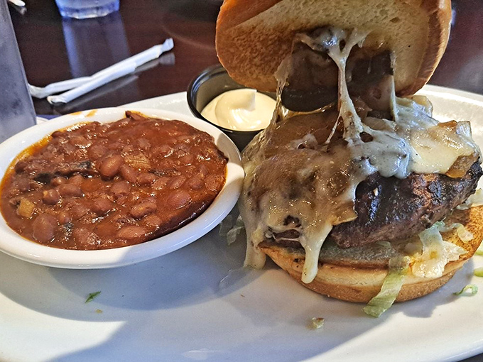 This burger doesn't just come with a side of beans—it comes with a side of happiness. Melted cheese cascades down like a dairy waterfall.