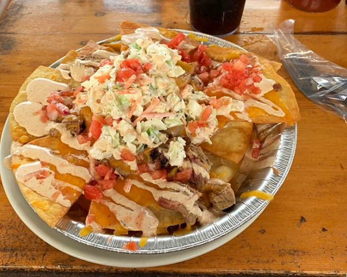 Barbecue nachos that laugh in the face of conventional tortilla chips. A mountain of pulled pork, cheese sauce, and fresh toppings worth scaling.