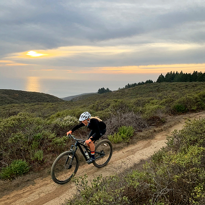 Mountain biking with an ocean sunset backdrop &ndash; because some exercise routines deserve better scenery than a gym's motivational poster.