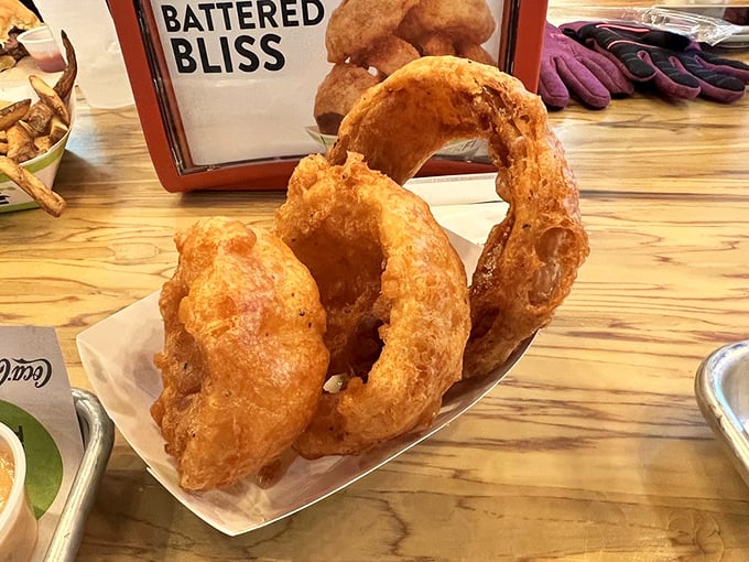 These aren't just onion rings &ndash; they're golden halos of happiness. Thick-cut, beer-battered, and fried to that perfect crunch that echoes when you bite.