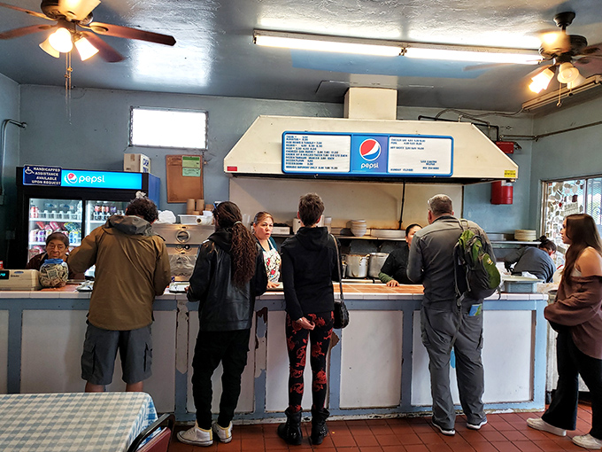 The ordering counter where patience is rewarded with plates of perfection. Notice nobody's complaining about the wait?