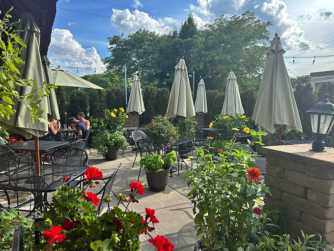 The patio garden blooms with flowers almost as colorful as the conversations happening between tables.