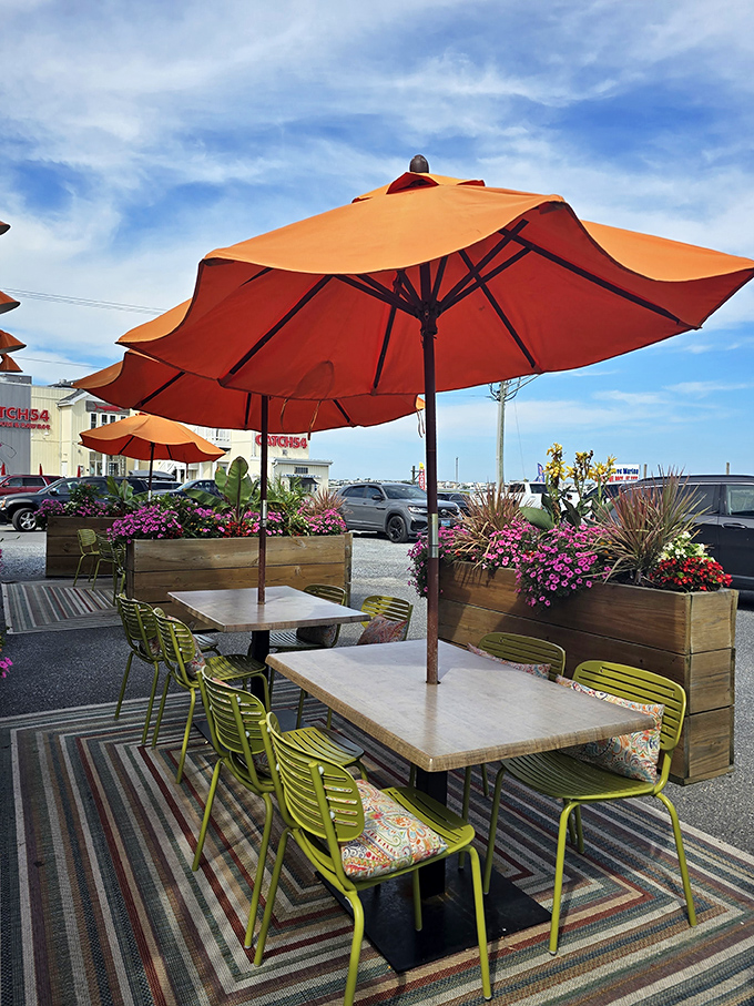 Outdoor dining with vibrant orange umbrellas and lime-green chairs—because flavor this bold deserves equally bold surroundings.