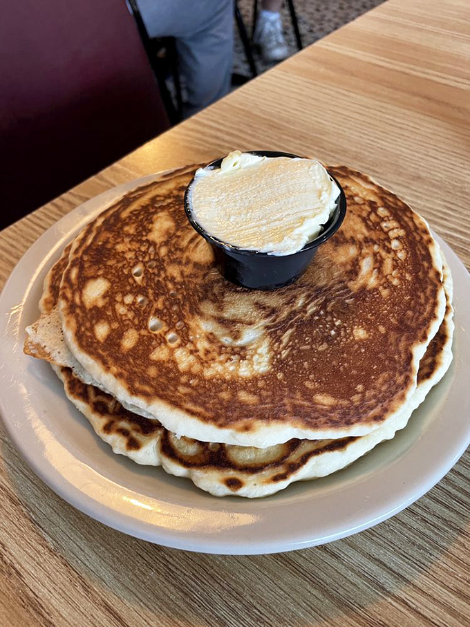 Pancakes so perfectly golden they belong in a museum. That butter cup on top is melting with anticipation.