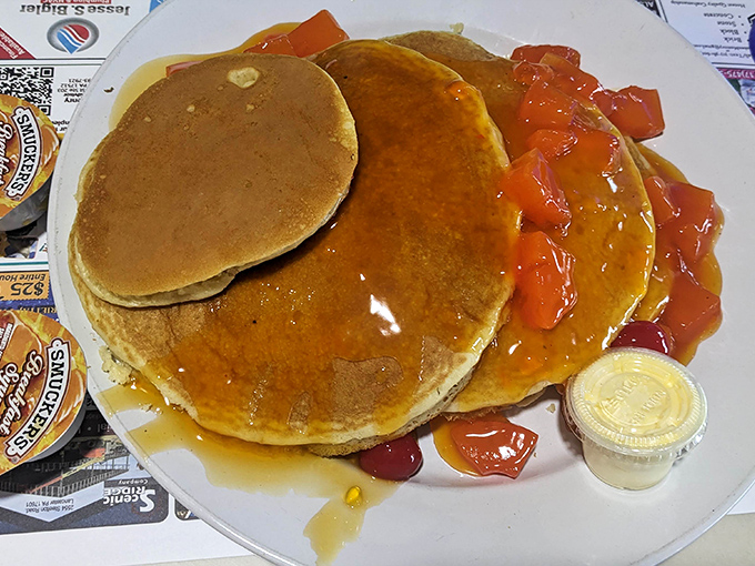 Pancakes stacked like edible gold coins, with strawberry topping that brings a tangy brightness to the sweet, fluffy foundation. Breakfast royalty. 