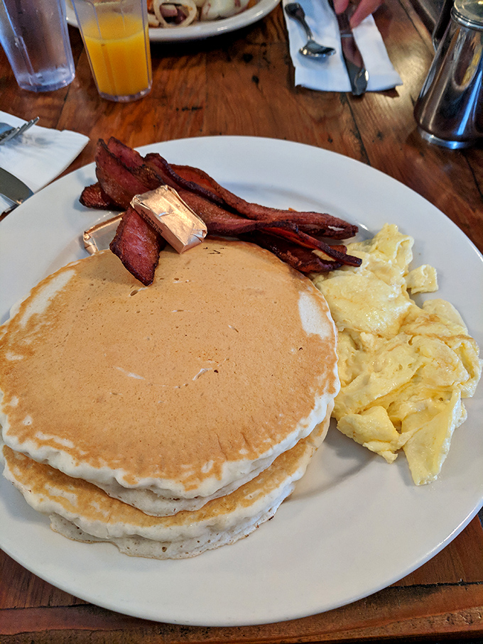These pancakes achieve the impossible trifecta: golden outside, fluffy inside, and substantial enough to support that river of syrup.