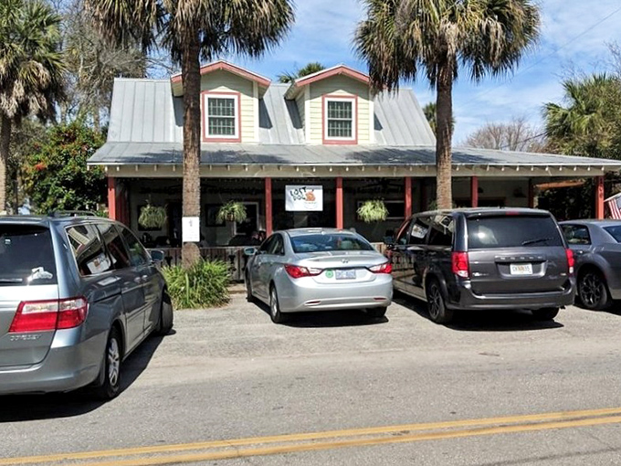 The parking lot view that signals you've arrived at the right place. That metal roof has sheltered countless hungry beach-goers.