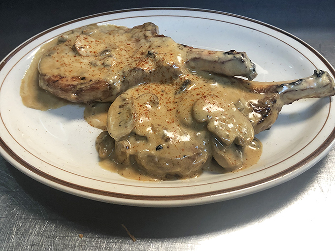 Pork chops swimming in mushroom gravy&mdash;a plate that whispers "Sunday dinner at grandma's" with every savory bite.