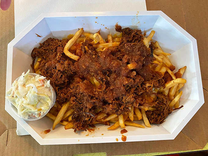 Pulled pork fries&mdash;a glorious mountain of crispy potatoes buried under tender meat and sauce, with coleslaw standing by to cool the flavor avalanche.
