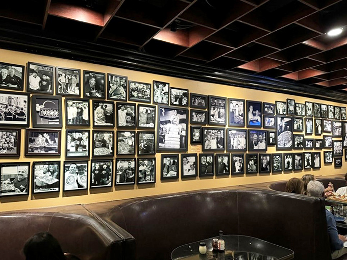 The wall of fame tells stories of pizza passion and celebrity visits—each black and white photo a chapter in Tony's legendary status among pizza aficionados.