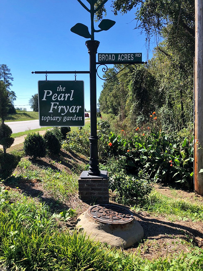 The unassuming entrance sign that marks the boundary between ordinary world and extraordinary garden. Like finding Narnia in rural South Carolina!