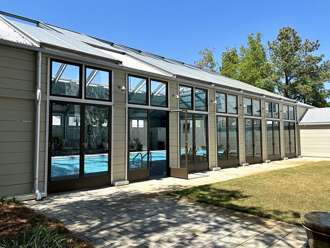 Floor-to-ceiling windows showcase one of Rosemary Beach's four distinctive pools, offering a refreshing alternative when you need a break from salt water.