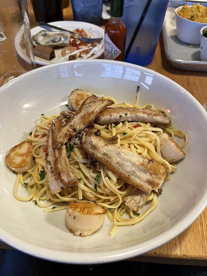 Pasta perfection! Tender scallops and perfectly cooked fish fillets rest atop a bed of linguine &ndash; proof that seafood and Italian make beautiful music together.