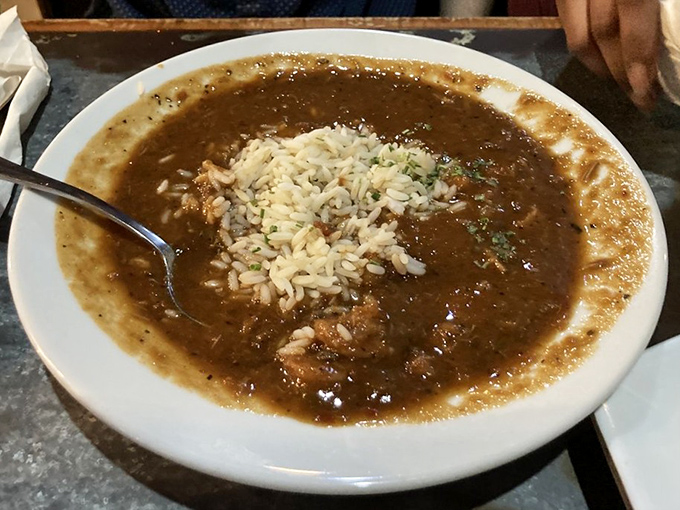 This isn't just gumbo—it's liquid Louisiana history in a bowl. The dark roux tells you someone in that kitchen knows exactly what they're doing.