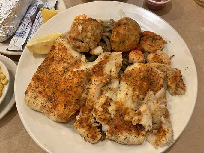 The Seaside Combo featuring perfectly cooked fish and two crab cakes that taste like they were made by someone who respects the ocean.