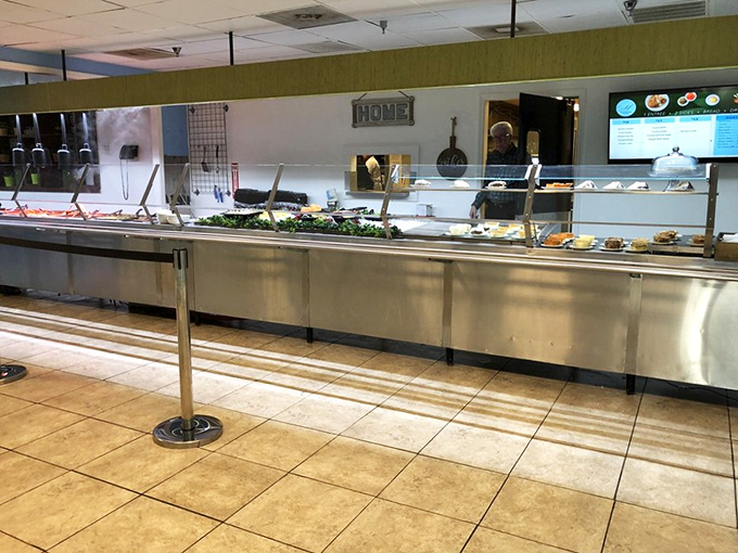 The serving line gleams with promise, a treasure trove of Southern delicacies waiting to fill your tray and expand your waistline.