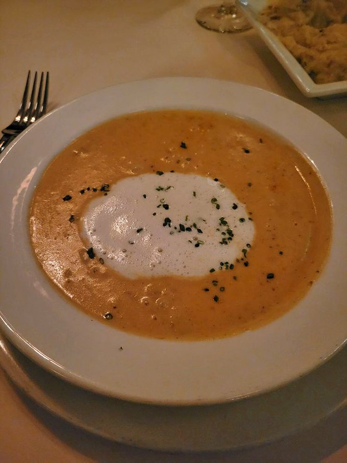 She-crab soup, crowned with a dollop of cream &ndash; Charleston's liquid legacy served with the kind of presentation that makes you pause before diving in. 