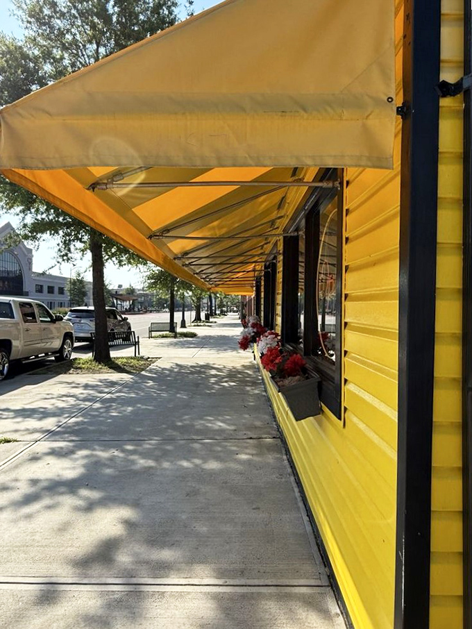 Sunshine bathes the sidewalk outside City Diner, where the yellow awning provides shade for those waiting to experience pancake nirvana.