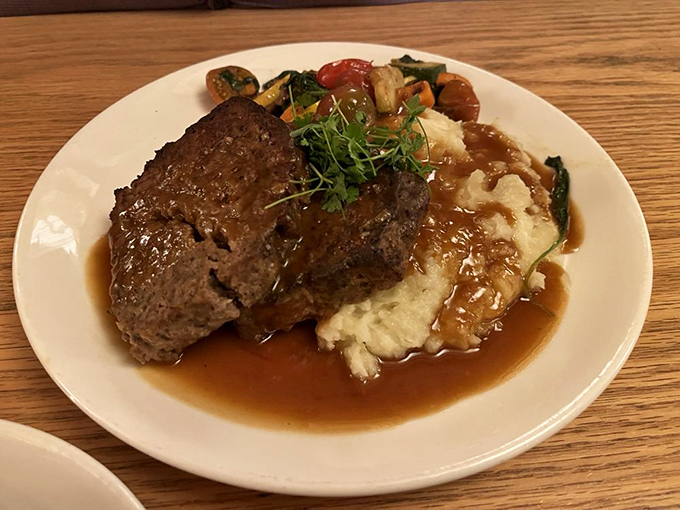 Meatloaf reinvented as the hero it deserves to be&mdash;tender, savory, and draped over creamy mashed potatoes with seasonal vegetables playing supporting roles.
