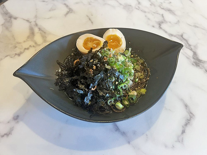 Black garlic oil transforms these noodles into edible art &ndash; mysterious, dramatic, and absolutely delicious.