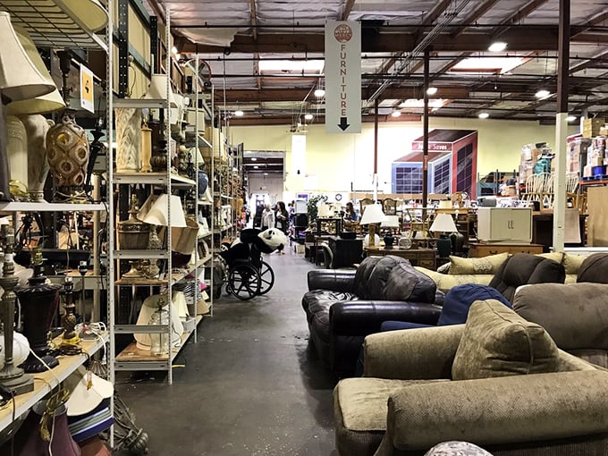 Sofa central! Plush seating options flank aisles of vintage lamps and home decor. That perfect reading nook is just a purchase away.