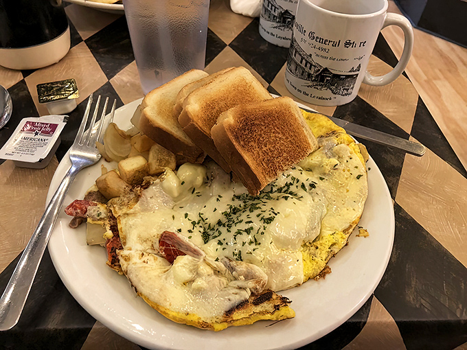 Breakfast doesn't get more serious than this&mdash;a golden omelet blanketing home fries with melted cheese that stretches with each forkful. 