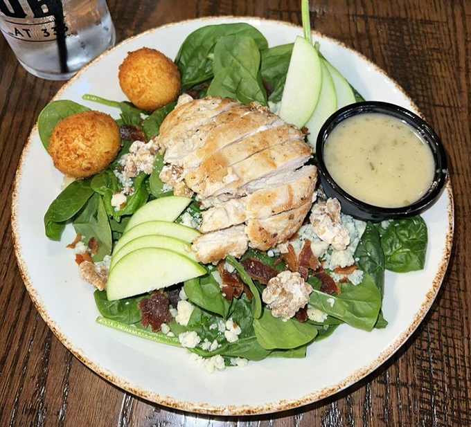 A spinach salad that makes eating greens feel like an indulgence rather than a obligation &ndash; those golden orbs are fried goat cheese, folks.