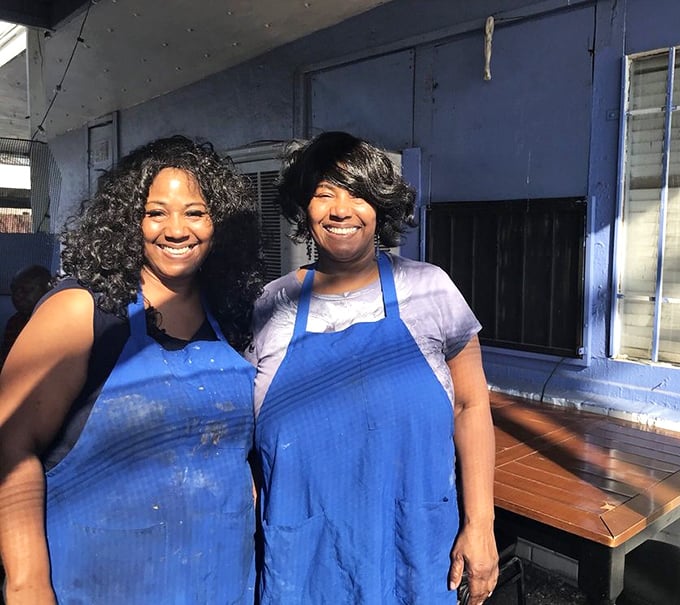 The smiles behind the magic! Blue aprons signal you're in the presence of people who take comfort food seriously.