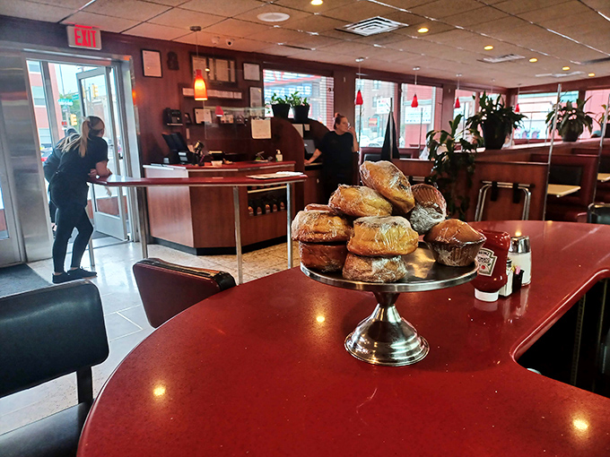 Where pastries go to show off. That display stand is the runway model of the diner world, flaunting its carb-loaded supermodels.