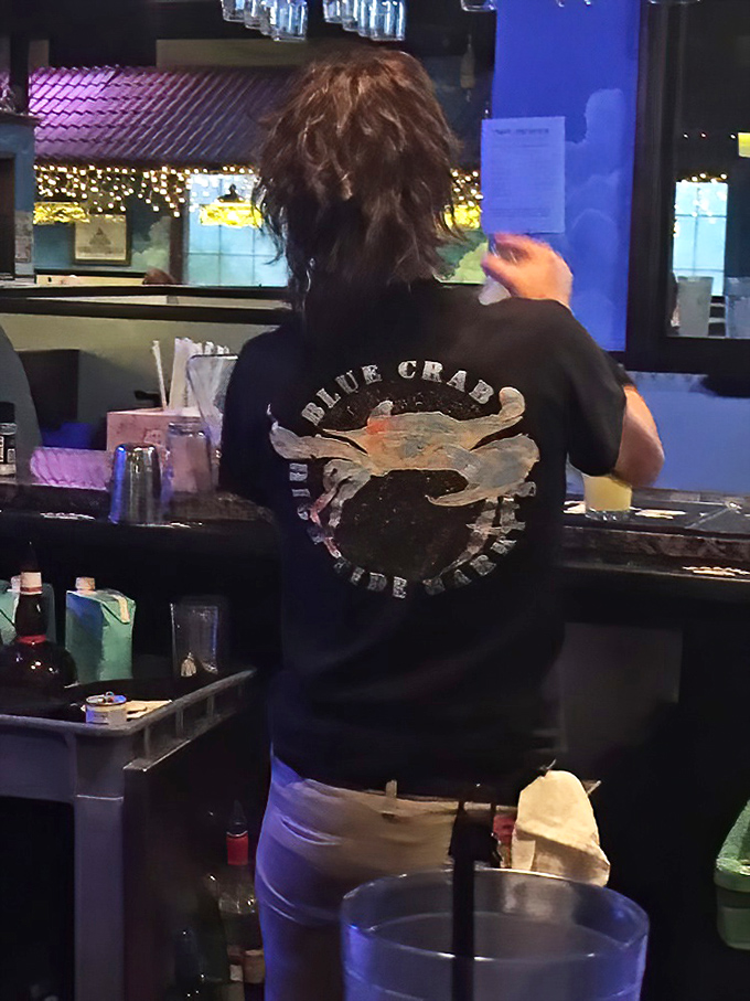 Staff proudly sport their blue crab heritage&mdash;these aren't just servers, they're seafood ambassadors guiding you through your crustacean adventure.