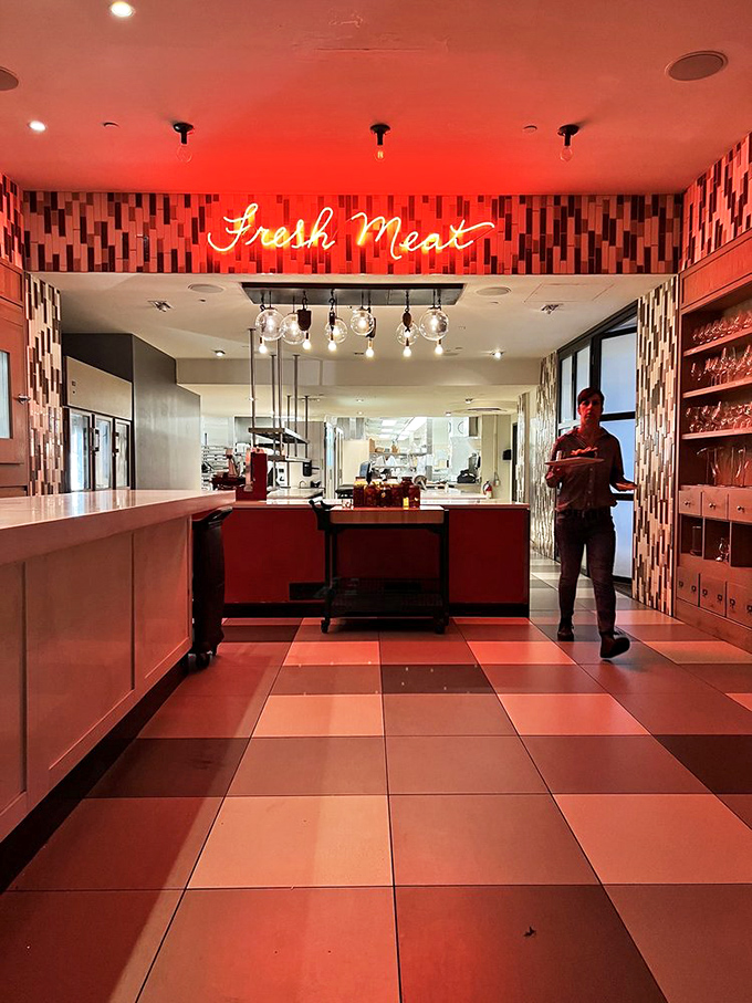 The "Fresh Meat" neon sign isn't just decoration; it's truth in advertising for a kitchen that takes protein very, very seriously.