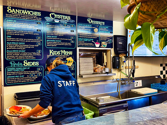 Where the magic happens&mdash;a staff member navigating the kitchen dance that transforms fresh catches into memorable meals for eager diners.