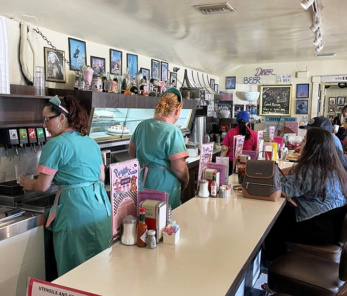 The waitstaff in period-perfect turquoise uniforms move with the choreographed efficiency of dancers who've been performing the same routine for decades.