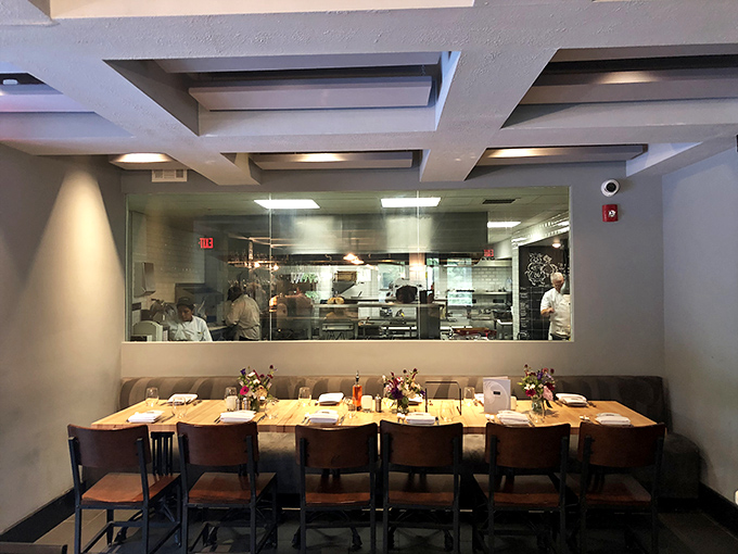 The open kitchen concept invites you into the culinary theater, where chefs perform their craft behind glass like rock stars on a gastronomic stage.