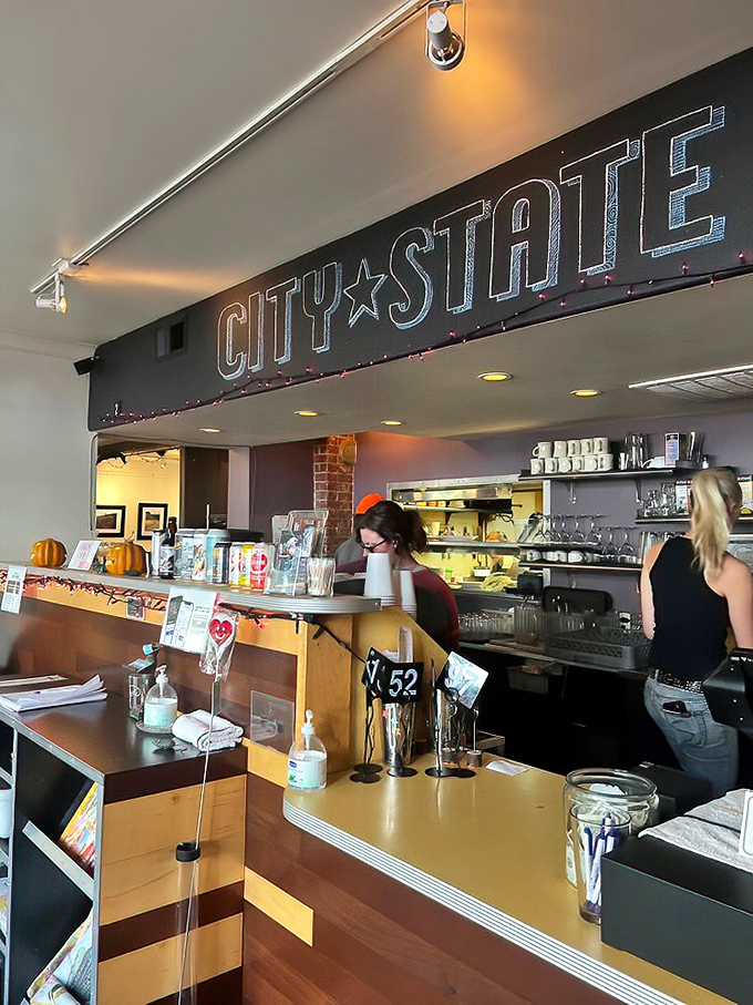 Behind that counter, breakfast magic happens under the watchful glow of the City State sign&mdash;where coffee flows and orders fly.